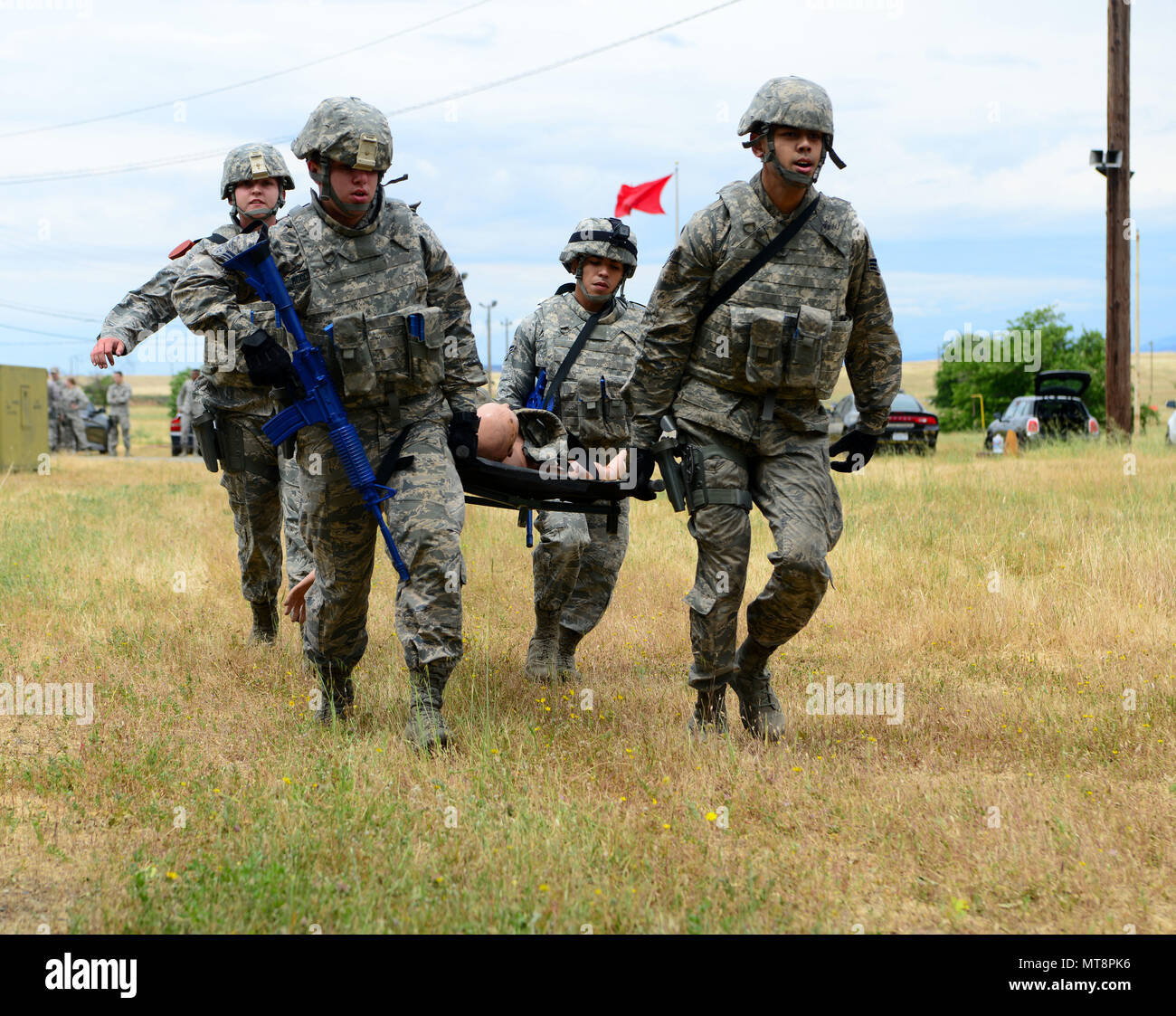 A team of 9th Security Forces Squadron defenders carry a stretcher ...