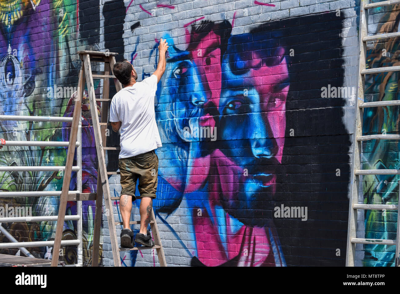 London, UK. 28 May 2018. Core246, a street artist, at work at "Meeting ...