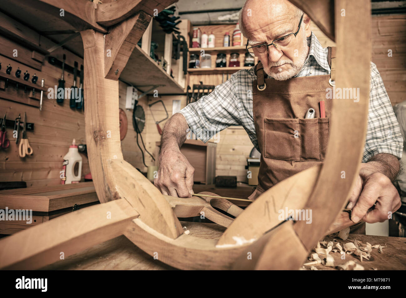 elderly carpenter builds a classic style chair Stock Photo - Alamy