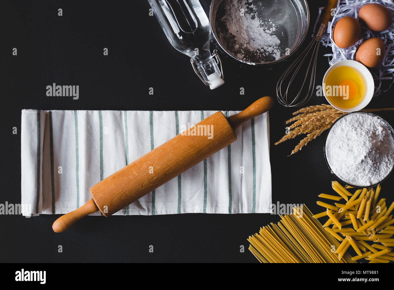 Pasta cooking ingredients on table kitchen table. Top view with space ...