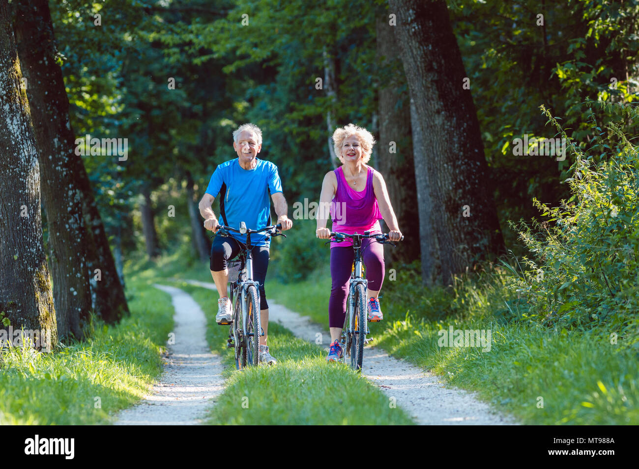 Elderly woman riding bicycle hi-res stock photography and images - Alamy