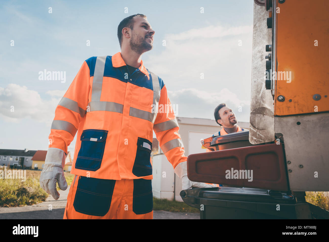 Waste collection bin man loading hi-res stock photography and images ...