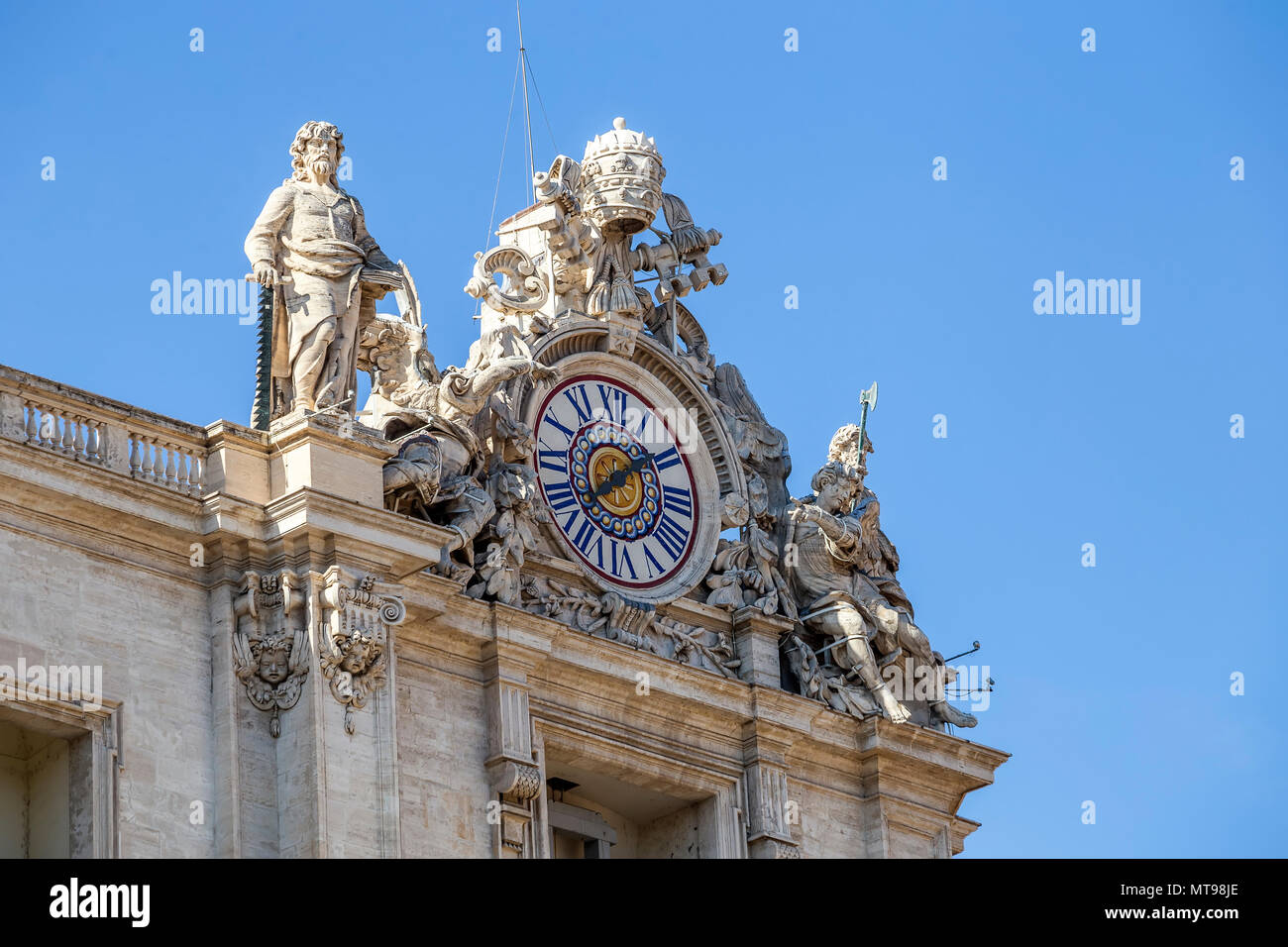 Vatican clock with sculptures on the roof of Basilica of Saint Peter, Vatican City, Vatican ...