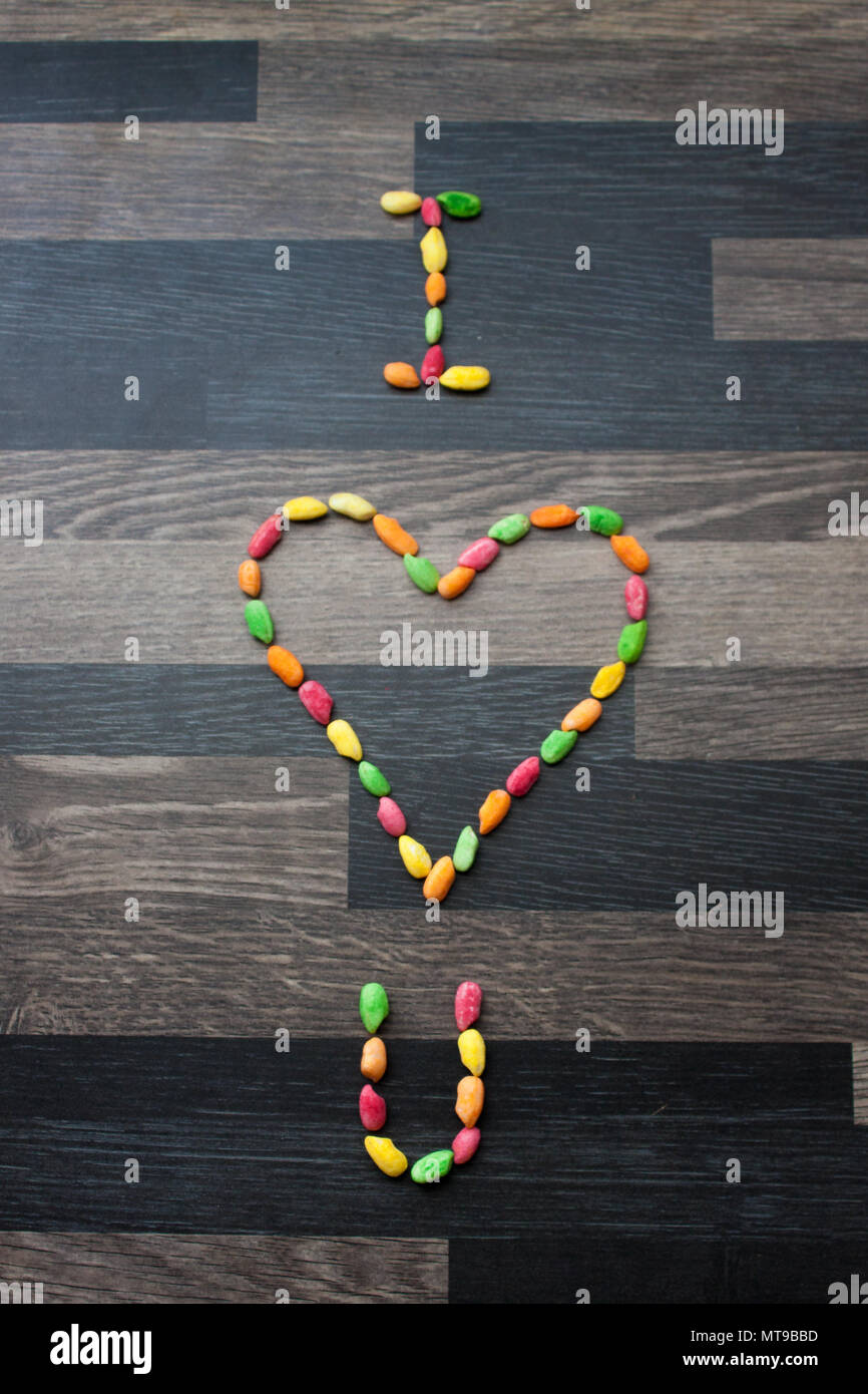 I Heart U made out of colorful rice on a gray kitchen counter to Stock ...