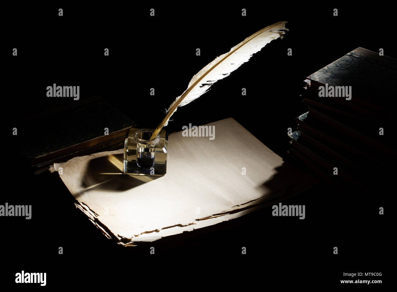 Old fountain pen, books and inkwell on a black background Stock Photo ...