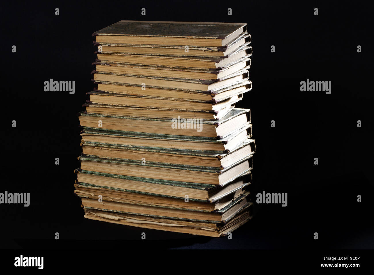 Old vintage books on a black background Stock Photo - Alamy