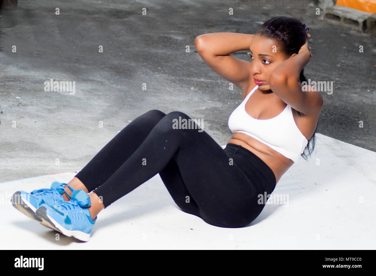 Beautiful African woman in sportswear doing exercises outside Stock ...