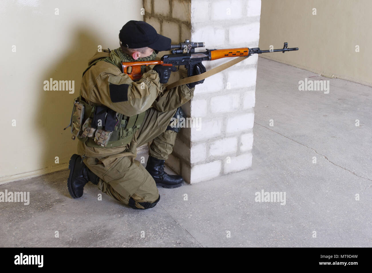 guerillas sniper with sniper rifle inside the building Stock Photo - Alamy