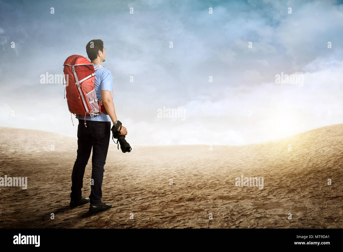 Back view of asian backpacker man holding camera on the mountain Stock ...
