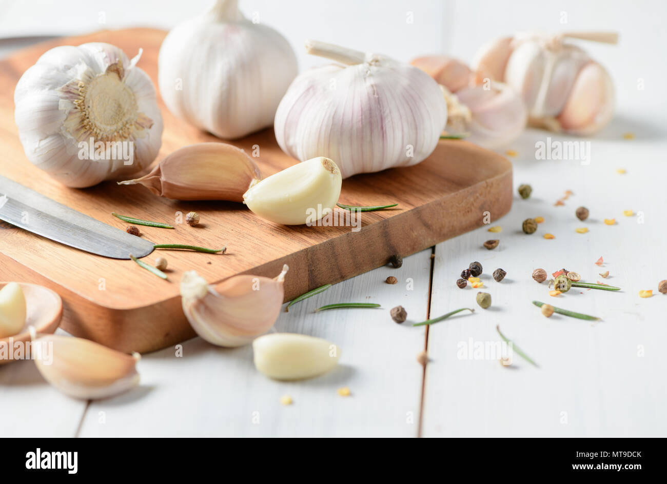 Garlic on wood block and white wood background, ingredient food and ...