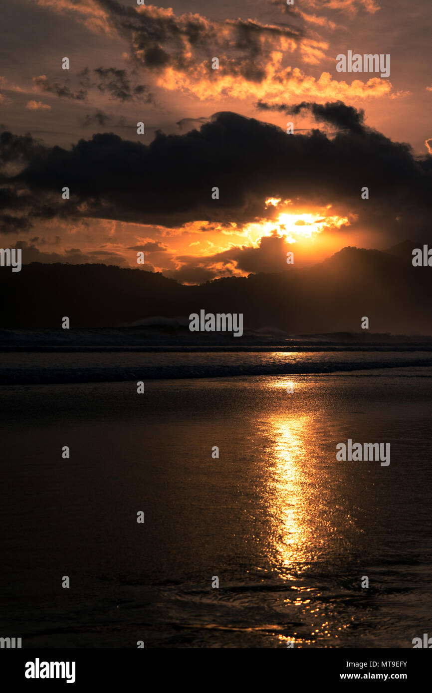 Indonesian Sunset on Red Island beach Stock Photo - Alamy
