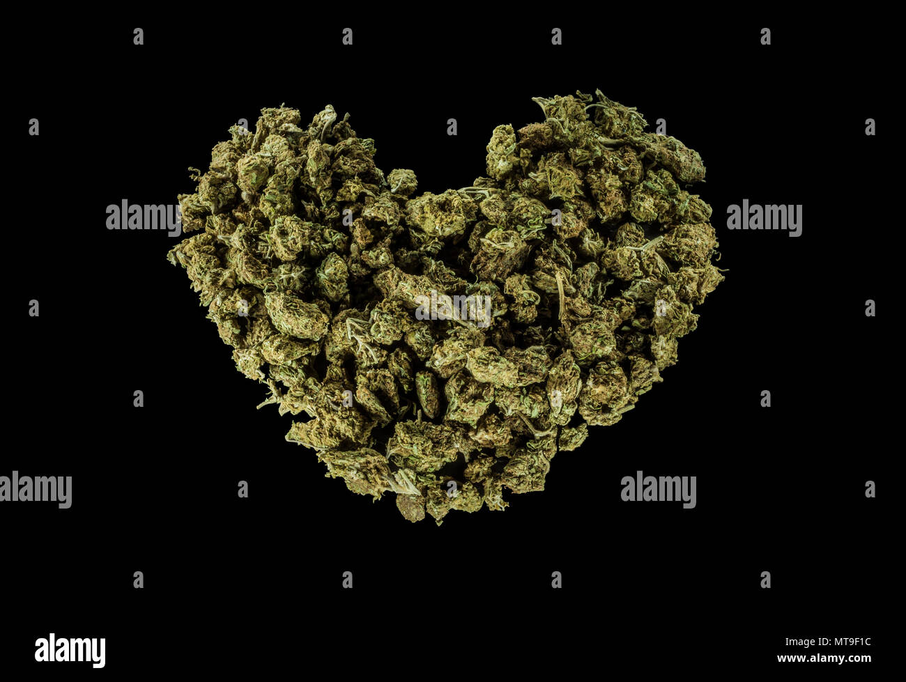 Green heart made of marijuana isolated on a black background Stock ...
