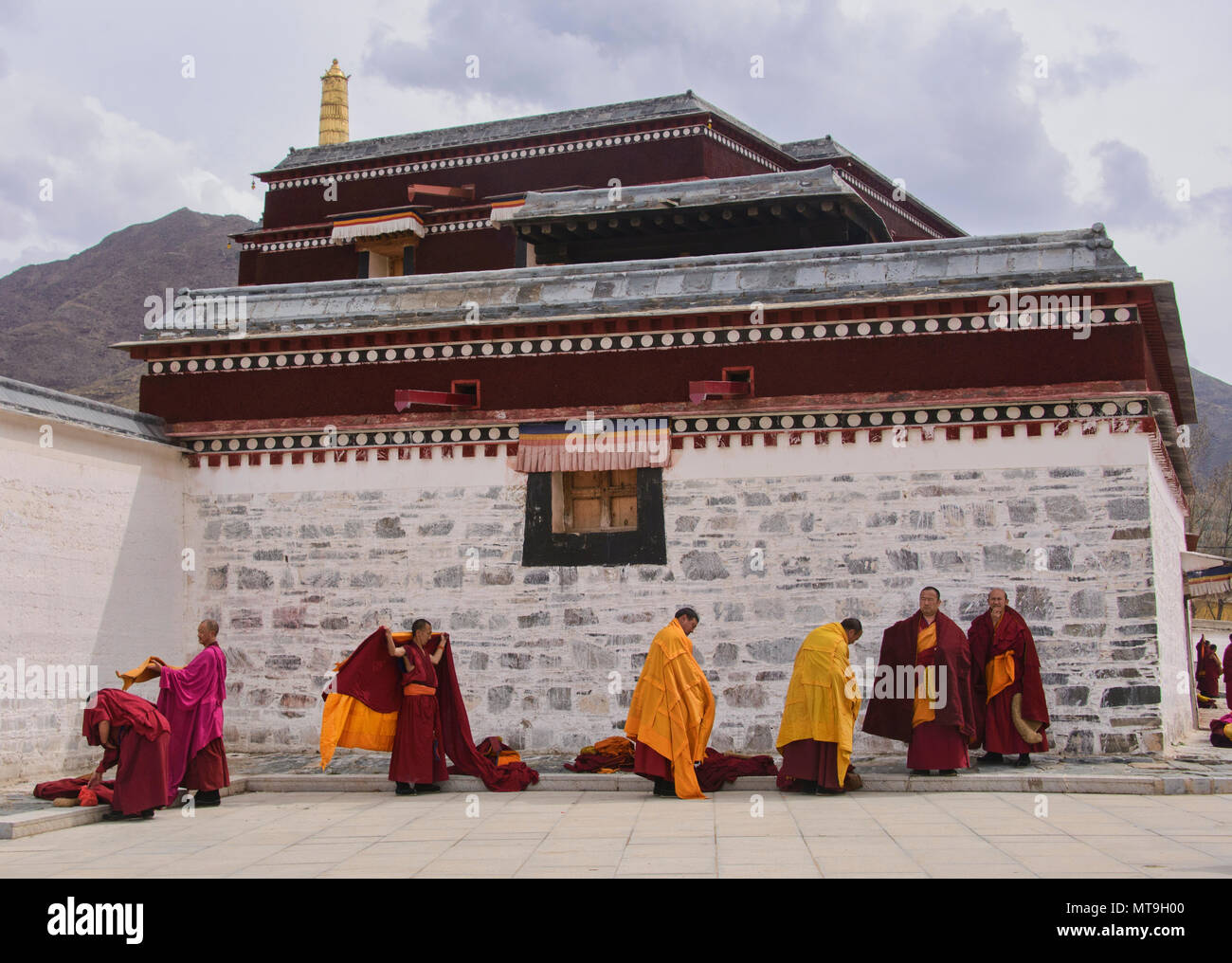 Gelukpa monks putting on their robes, Labrang Monastery, Xiahe, Gansu ...