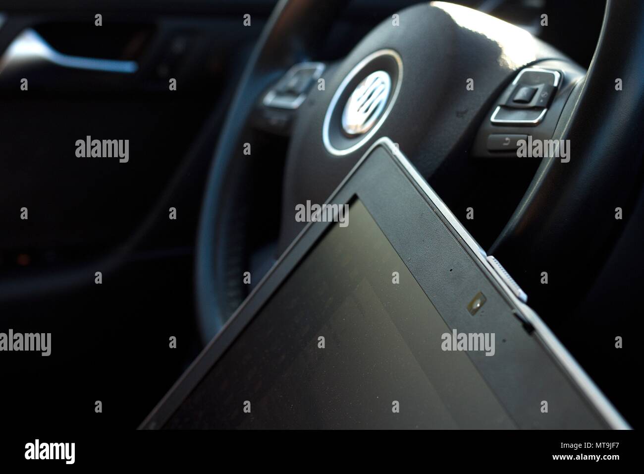 Laptop computer display in front of steering wheel of a car Stock Photo ...