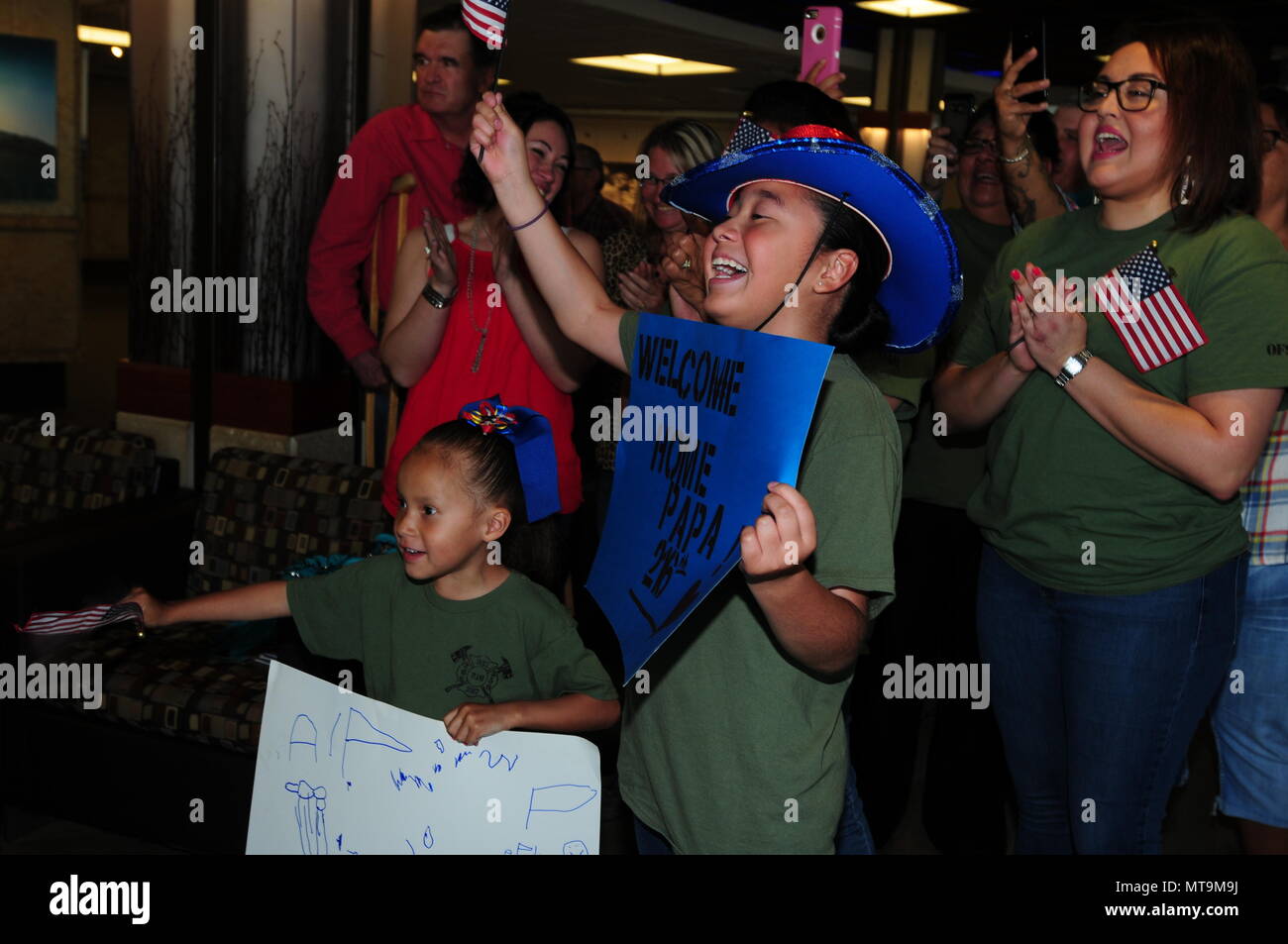 Tianna, center, and her sister, Rayah, wait to embrace and welcome ...