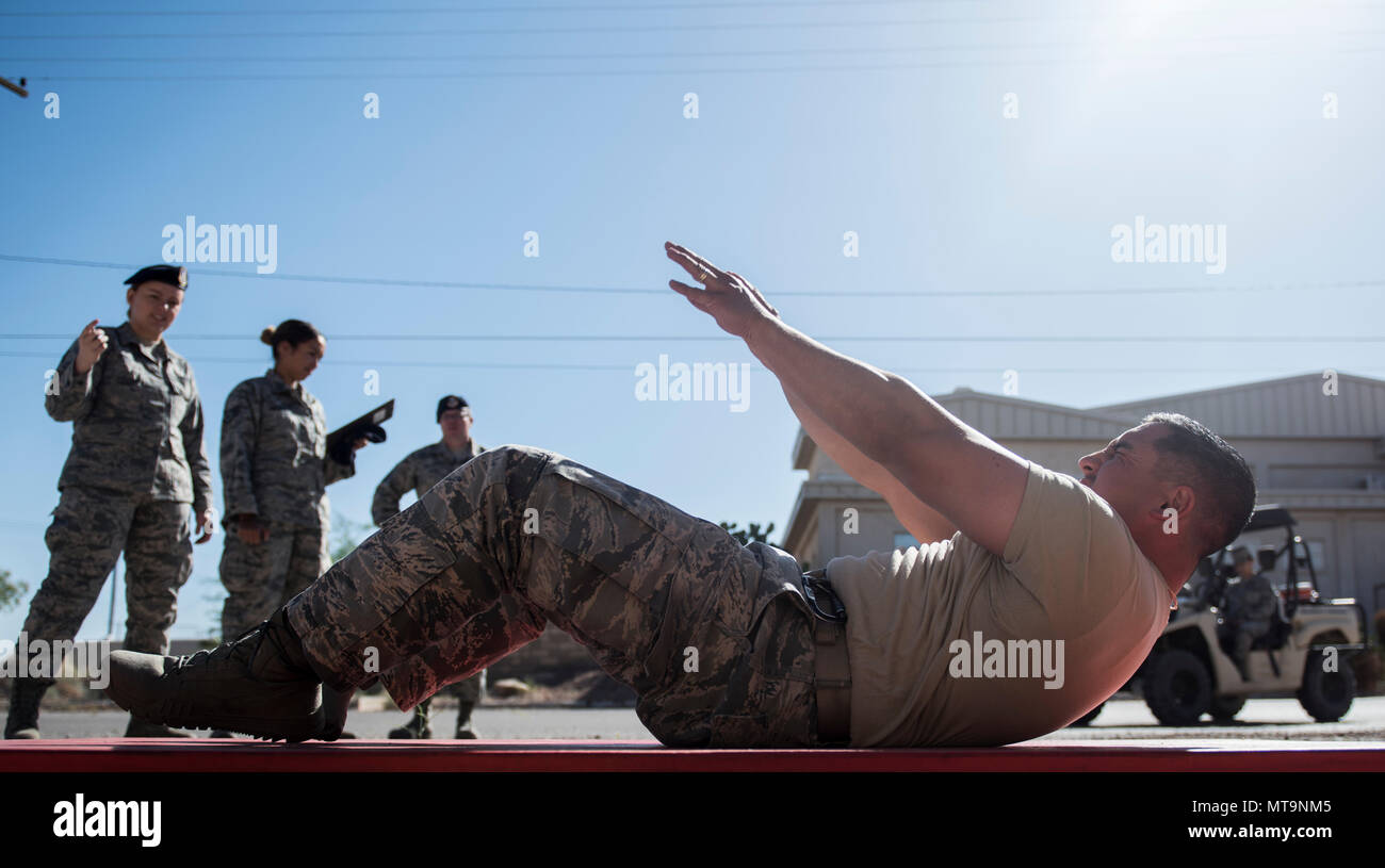 SSgt. Gabriel Cuevas, K-9 handler assigned to the 99th Security Forces Squadron, does a modified ...