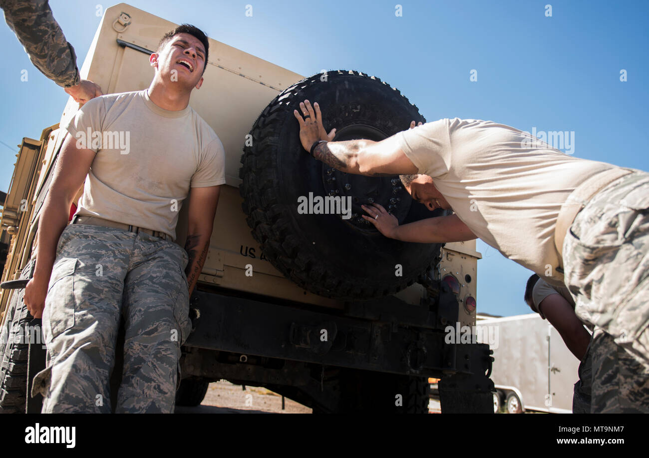 Airmen assigned to the 99th Security Forces Squadron push a Humvee ...