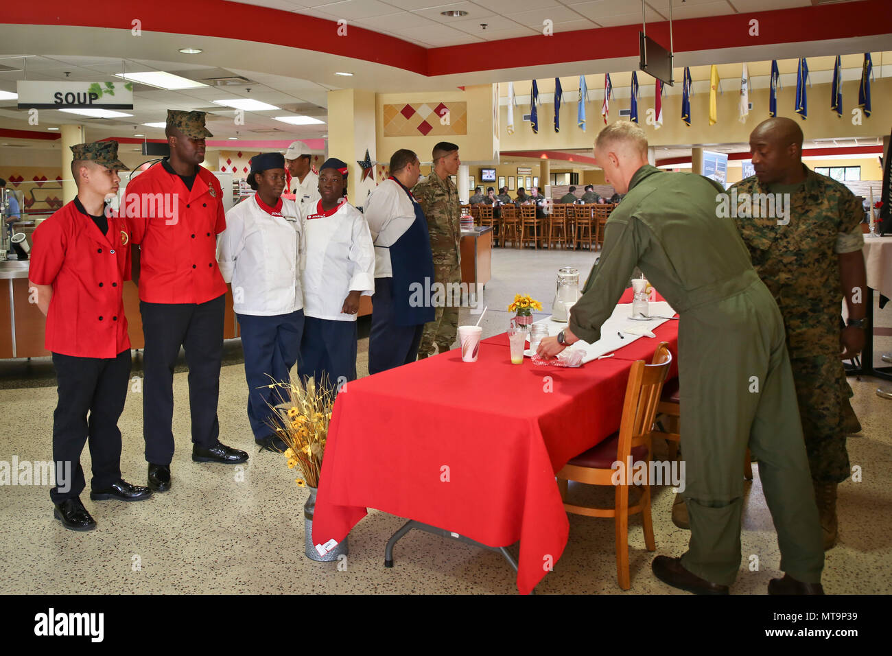 Teams of chefs await the judge’s decision during the quarterly cook off ...