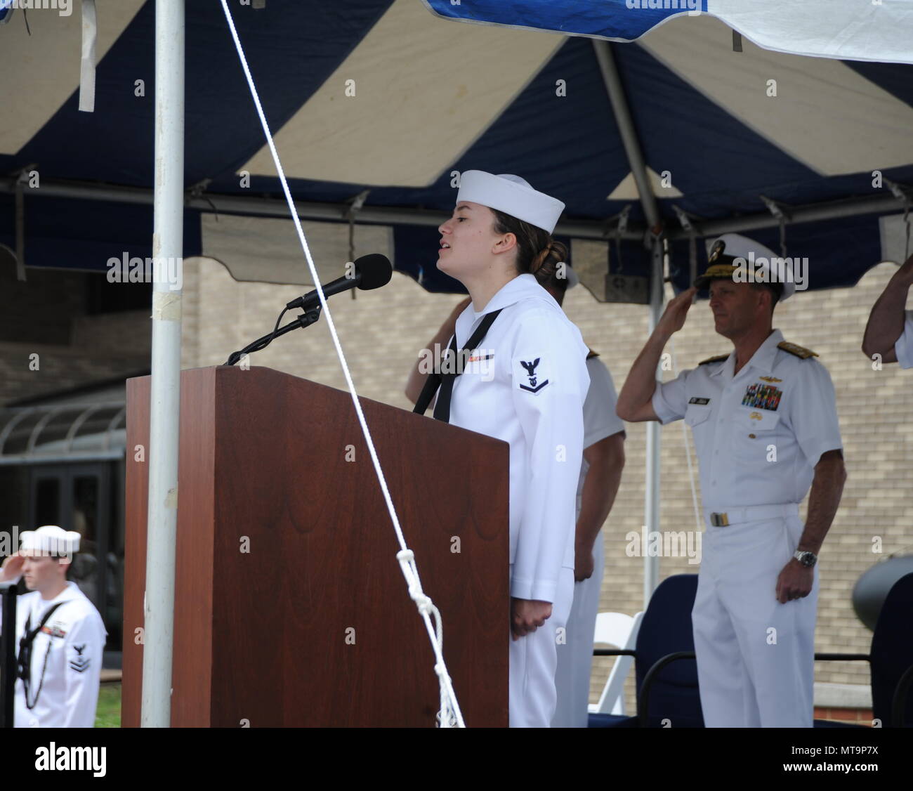 Musician Third Class Amanda Thompson sings the National Anthem at the ...