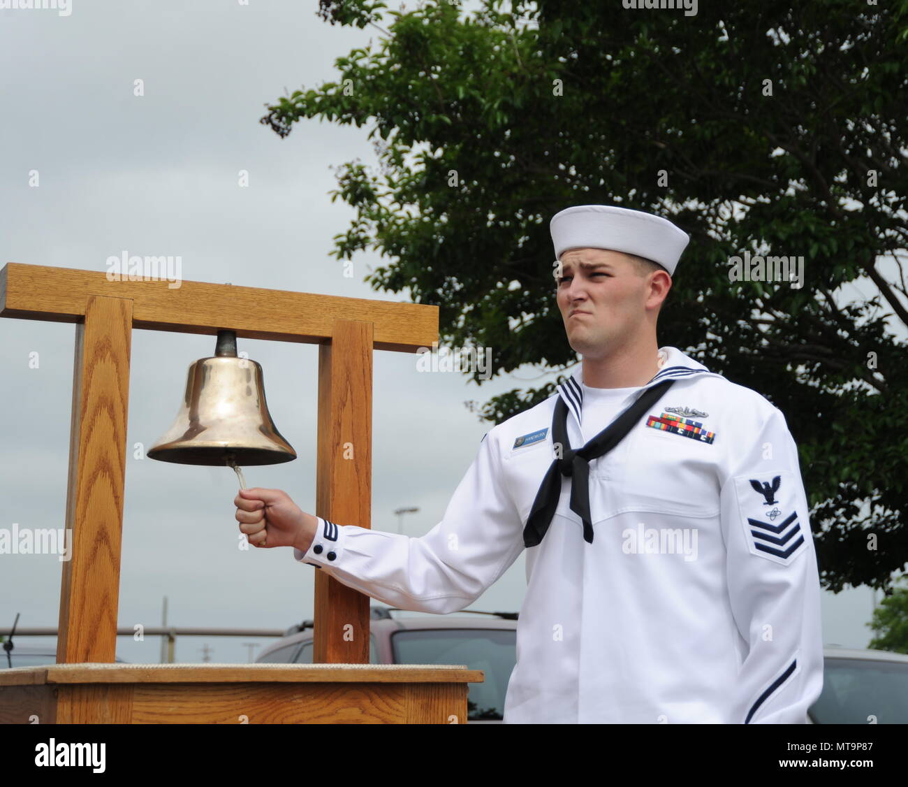 Electronics Technician Second Class Garrett Handwork strikes the bell ...