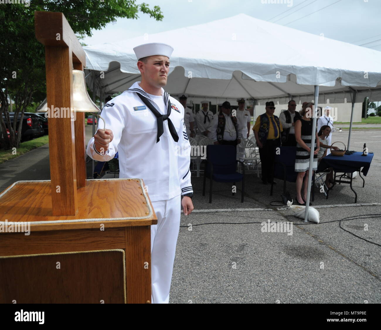Electronics Technician Second Class Garrett Handwork strikes the bell ...