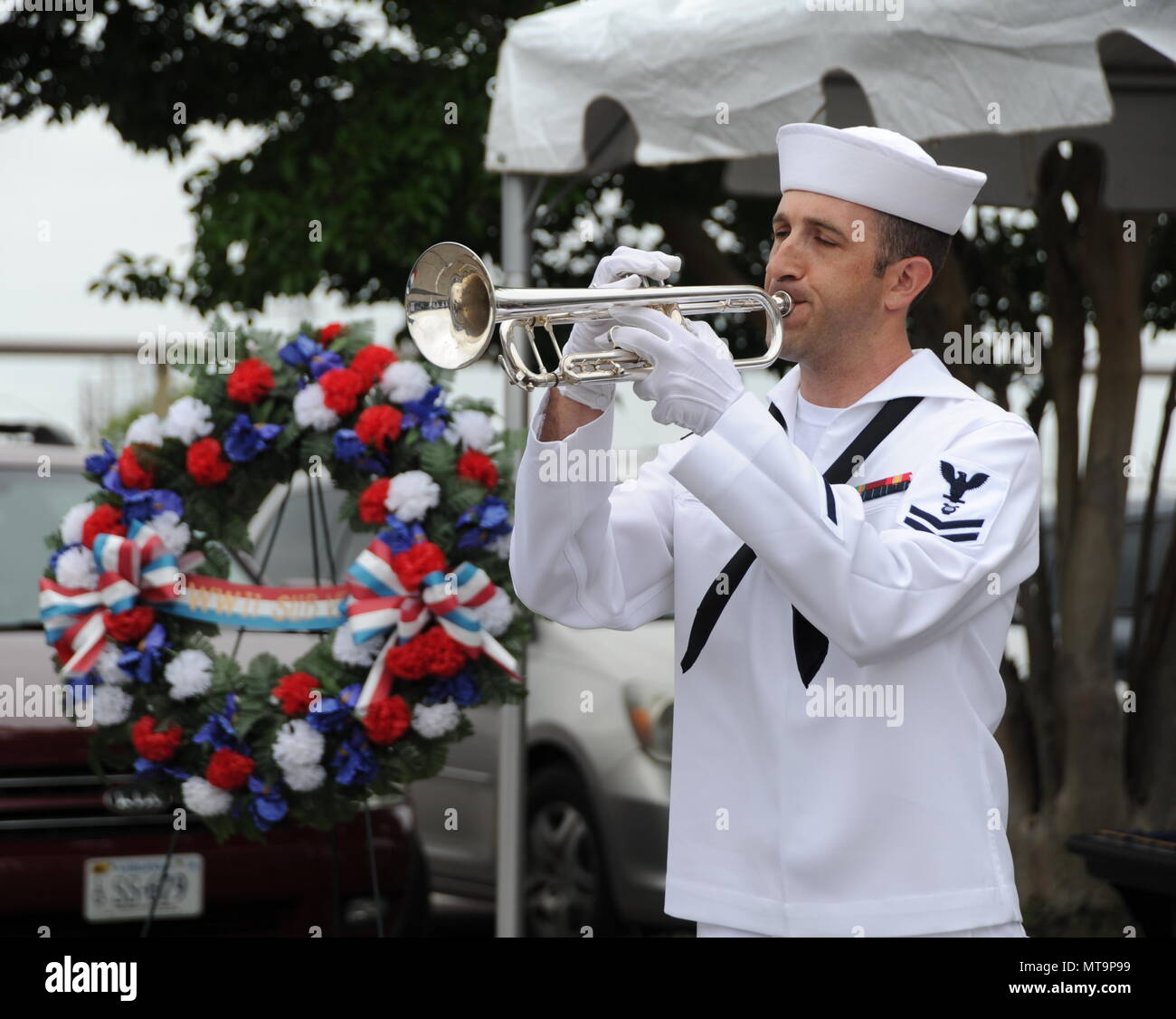 Musician Second Class Kiel Senninger plays Taps after the Tolling of ...
