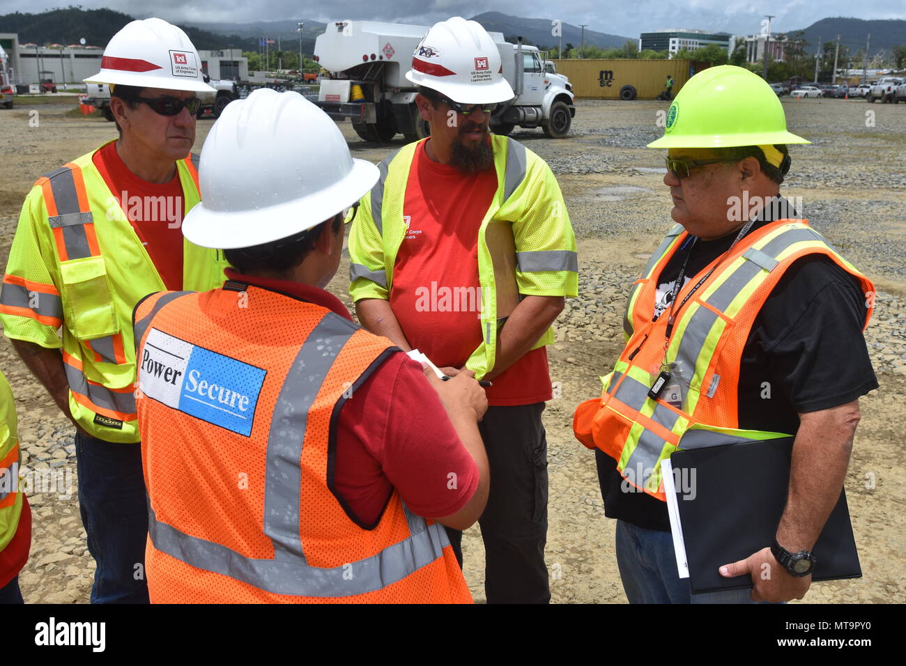 CAGUAS, Puerto Rico – USACE employees discuss the closeout process with ...