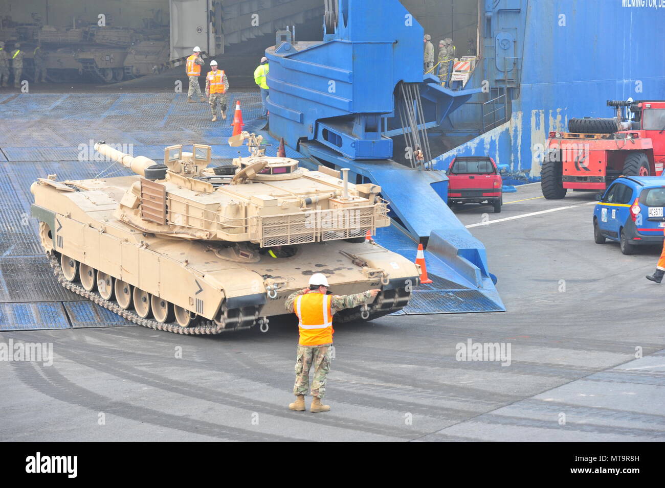 A U.S. Army Soldier guides an M1 Abrams Main Battle Tank from 1st ...