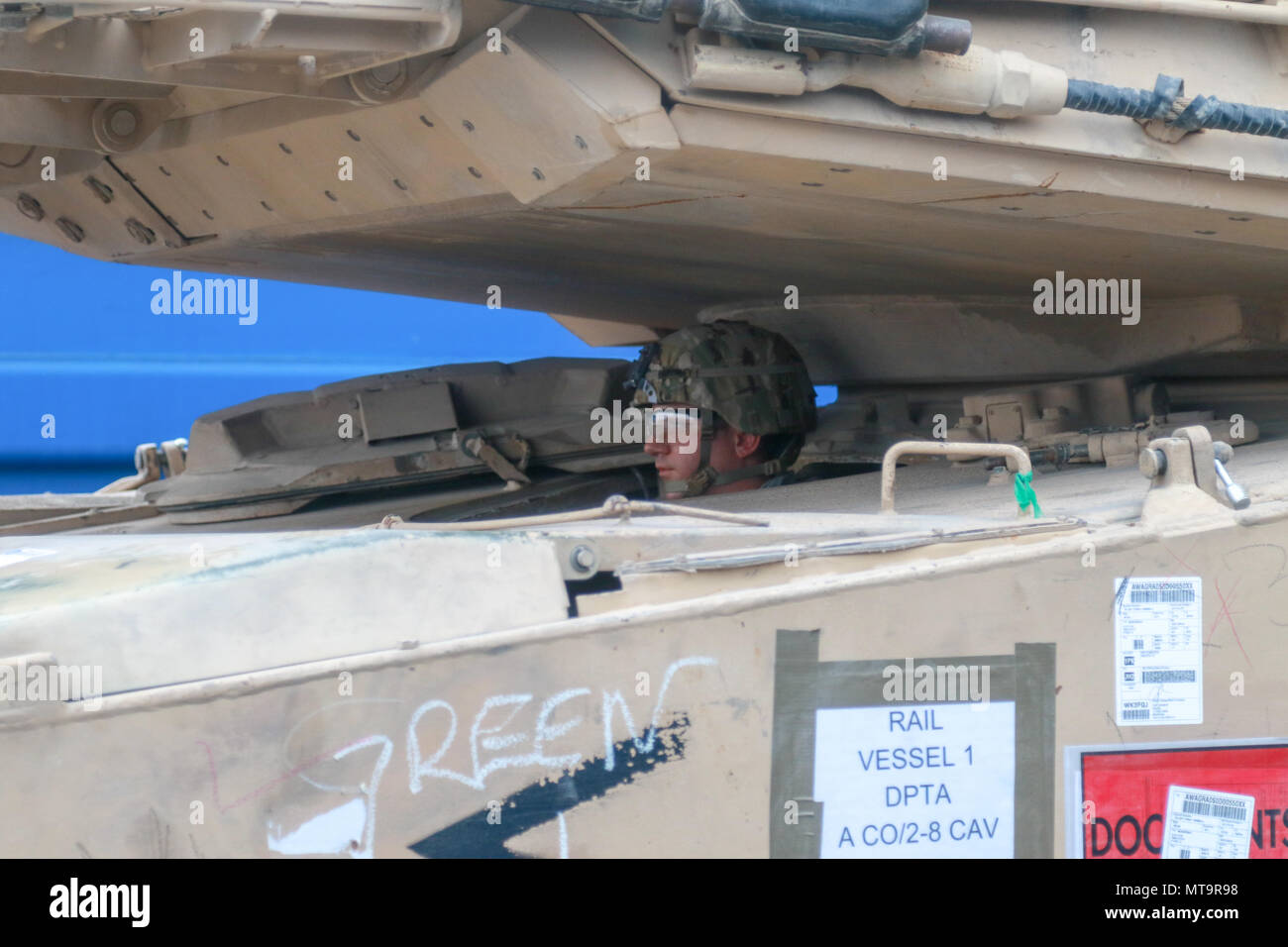 Port operations are underway unloading combat vehicles of the !st ...
