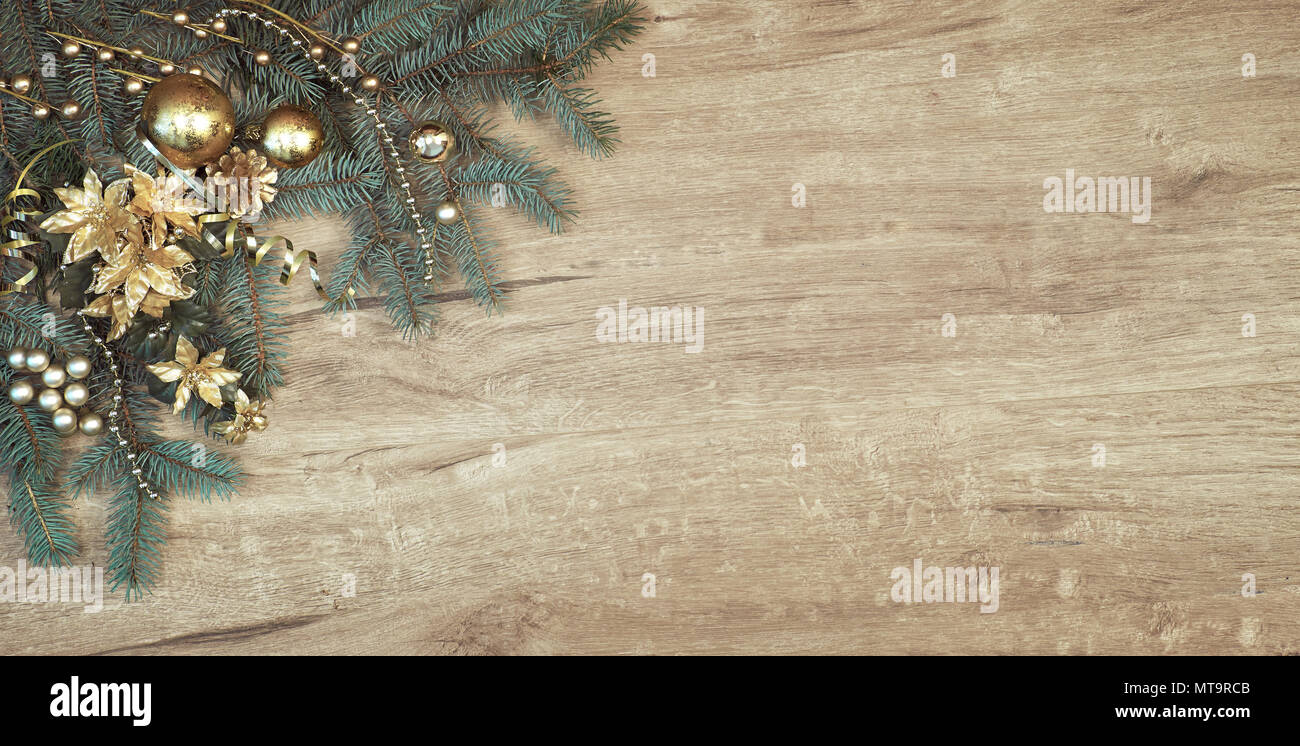 Christmas background on wood with a corner of decorated fir tree ...