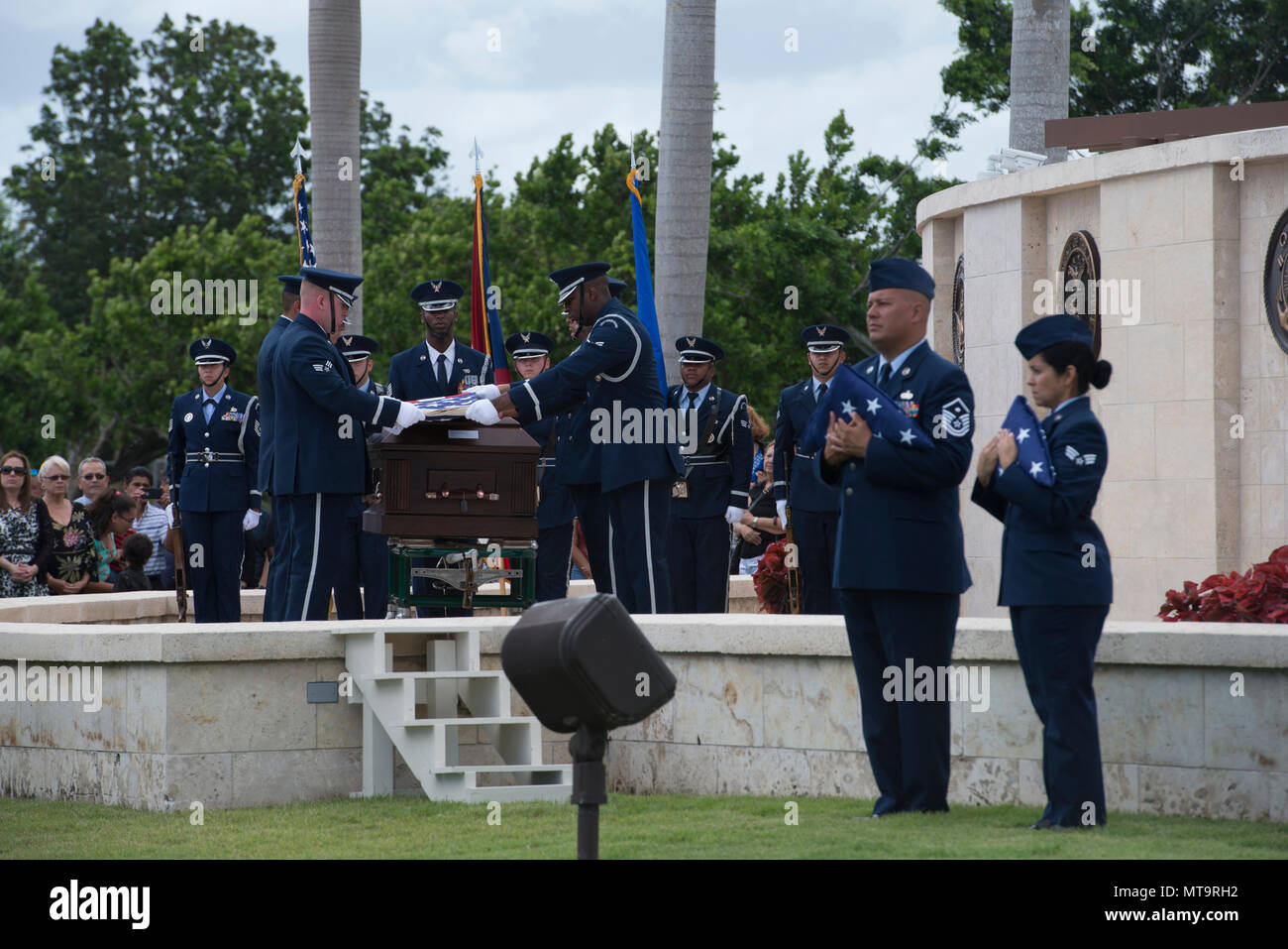 Airmen assigned to the U.S. Air Force Honor Guard fold an American flag ...