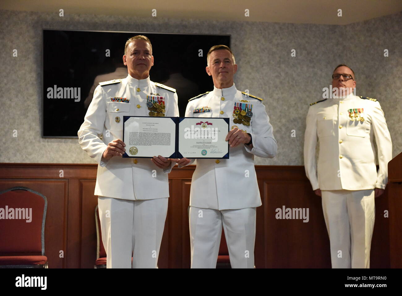 U.S. Coast Guard Commandant Adm. Paul F. Zunkuft, right, presents U.S ...