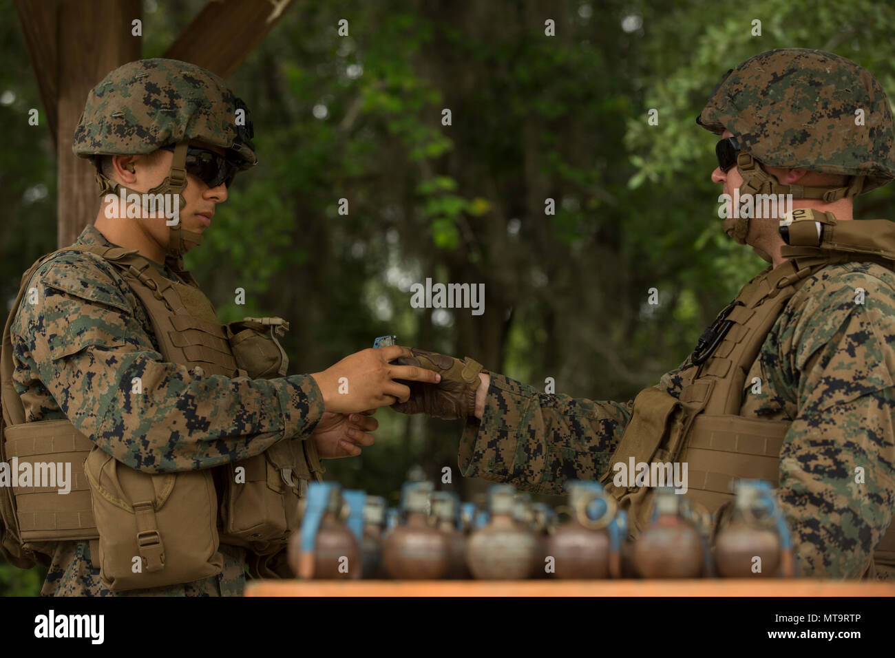 U.S. Marine Corps Gunnery Sgt. Nicholas Miller hands an M69 training ...