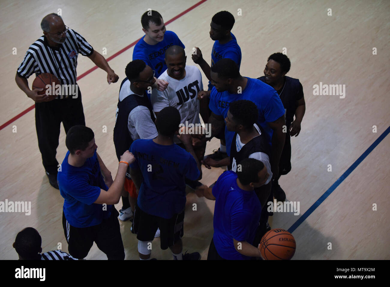 The 2nd Security Forces Squadron basketball team huddles up before the ...