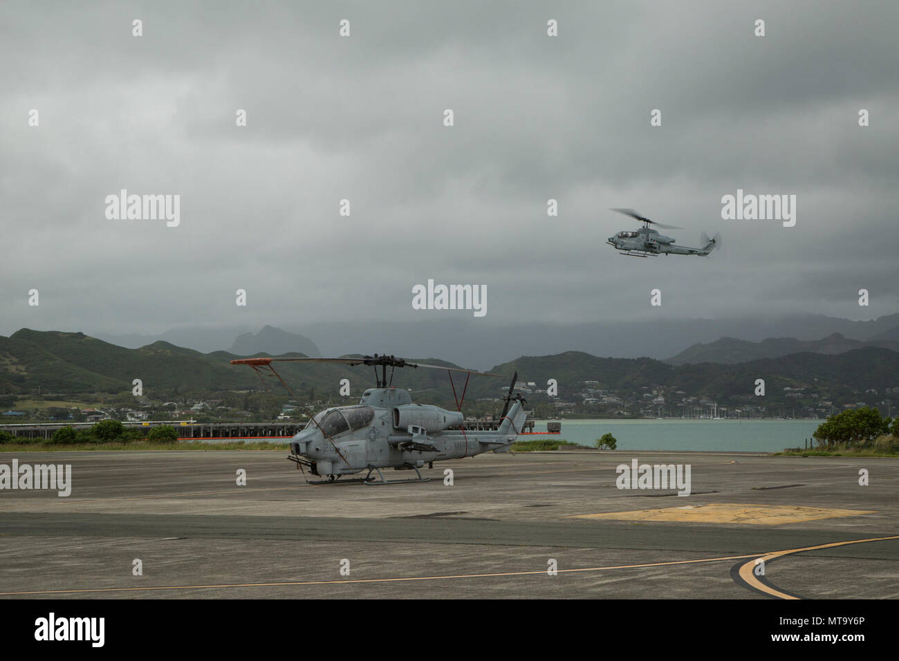 Two AH-1W Super Cobra helicopters prepare for landing on Marine Corps ...