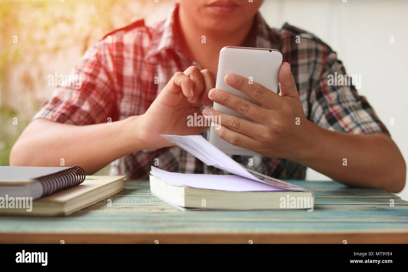 hand of people, student looking and pressing phone on wood table in ...