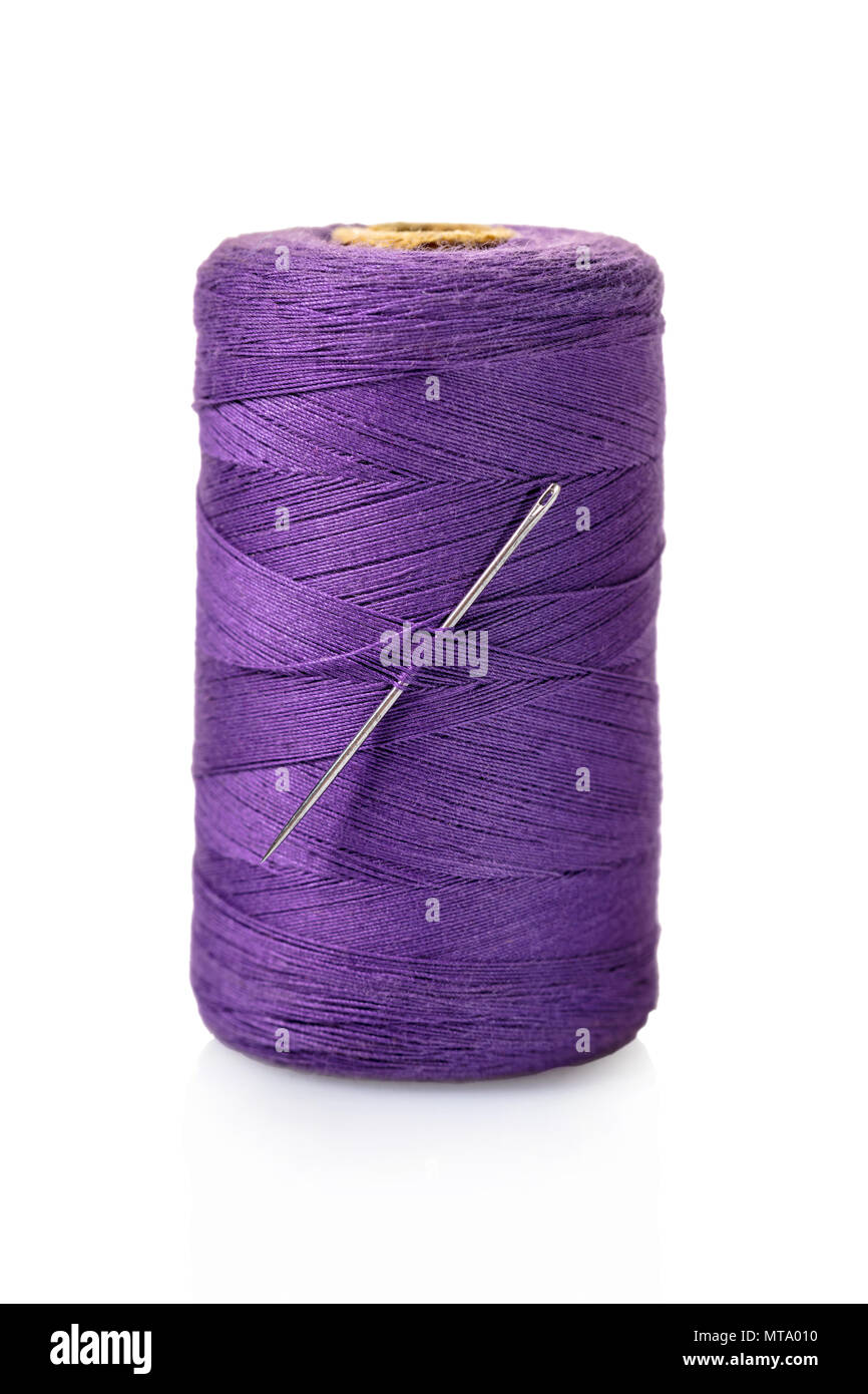 spool of purple threads on a white isolated background Stock Photo - Alamy
