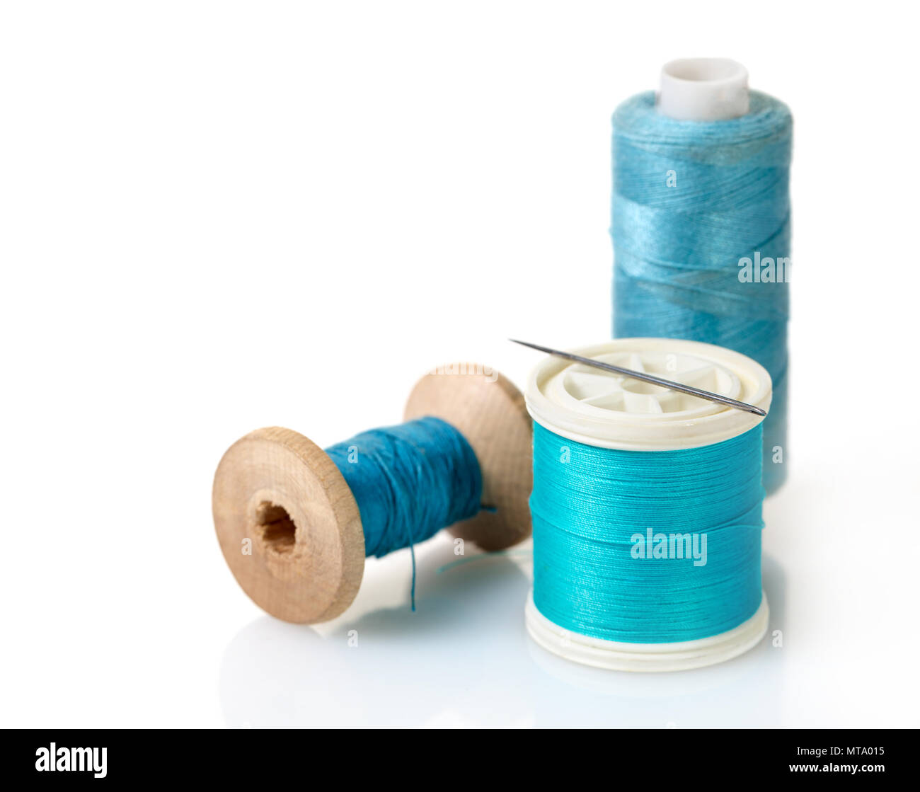 spool of blue threads on a white isolated background Stock Photo - Alamy