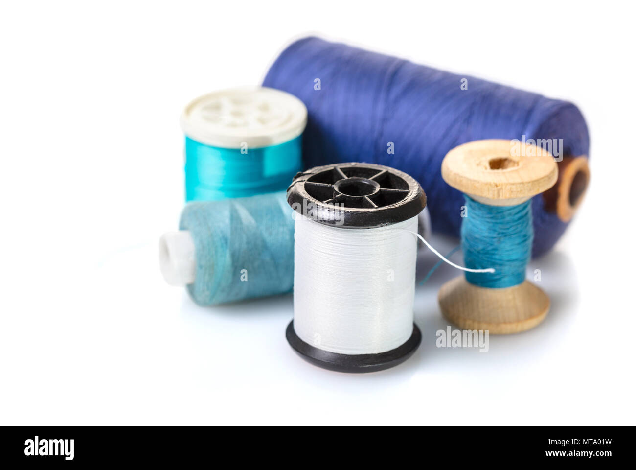 coils with colorful thread on white background Stock Photo - Alamy