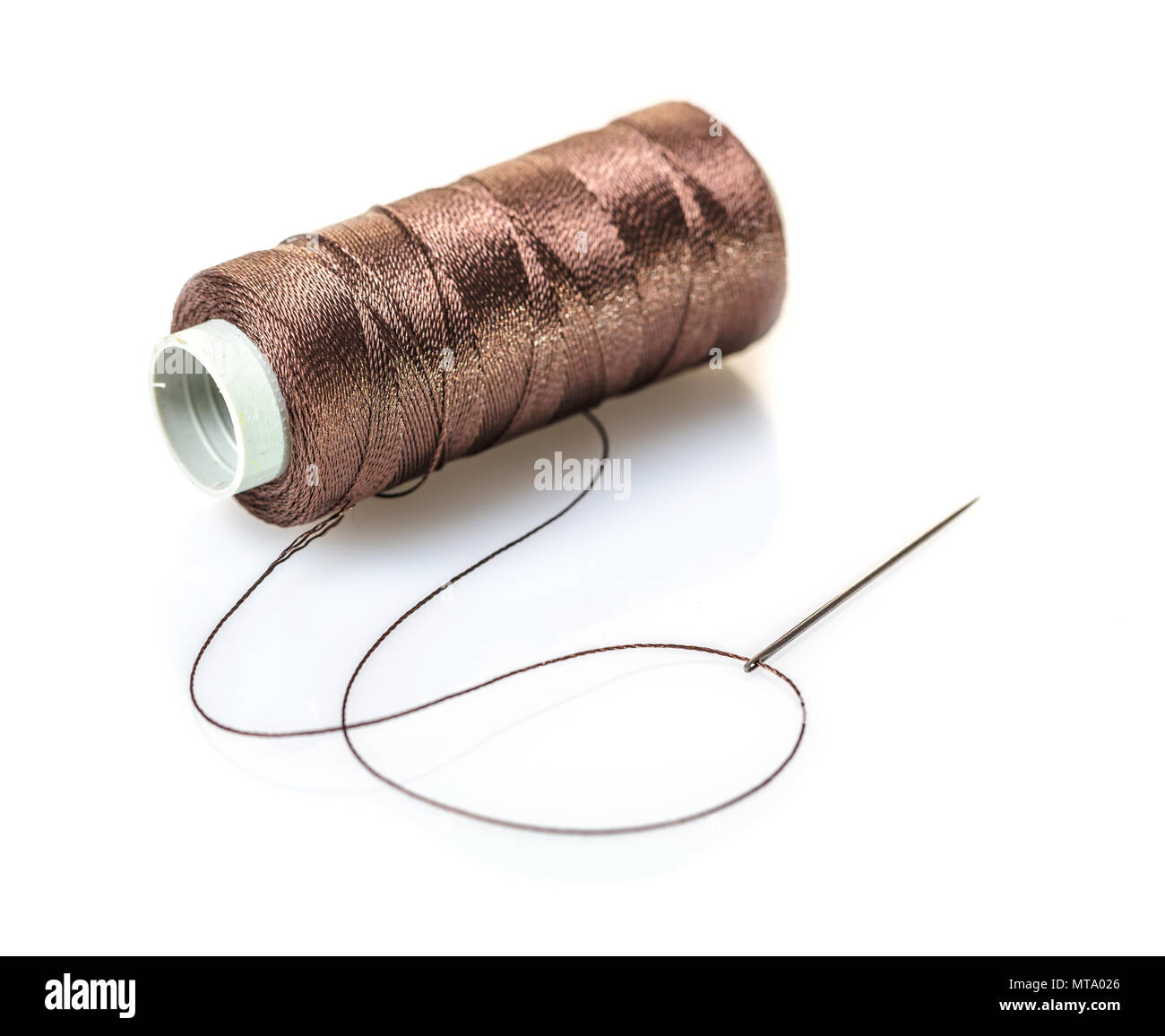 spool of brown threads on a white isolated background Stock Photo - Alamy