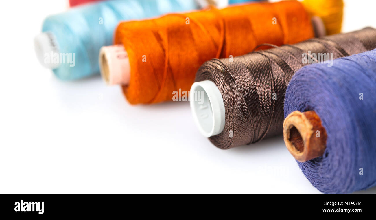 coils with colorful thread on white background Stock Photo - Alamy