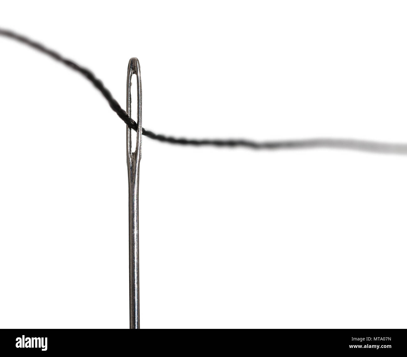 black thread in a needle on a white isolated background Stock Photo - Alamy