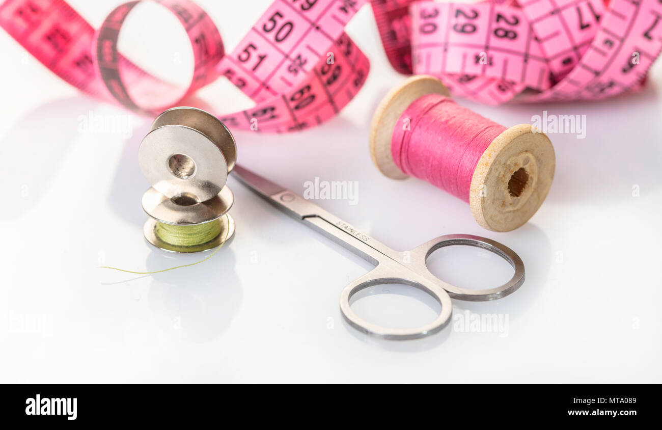 spool of pink thread and meter on white background Stock Photo - Alamy