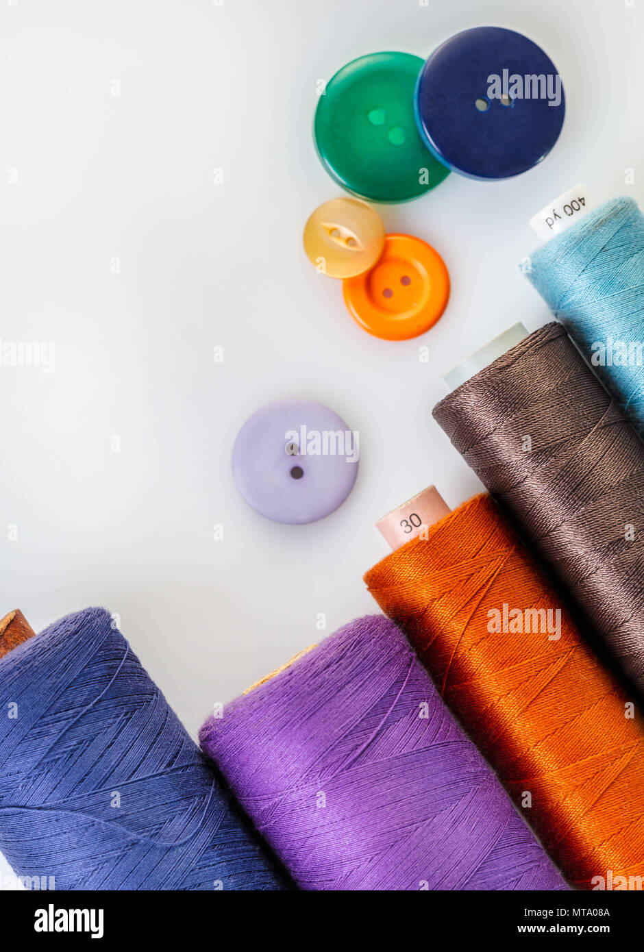 coils with colorful thread on white background Stock Photo - Alamy