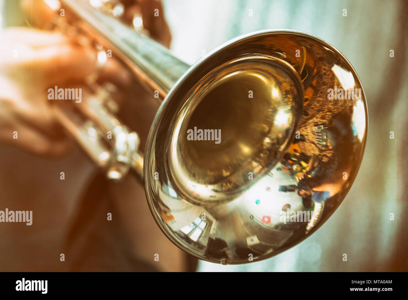 Trumpeter is playing on a silver trumpet Stock Photo - Alamy