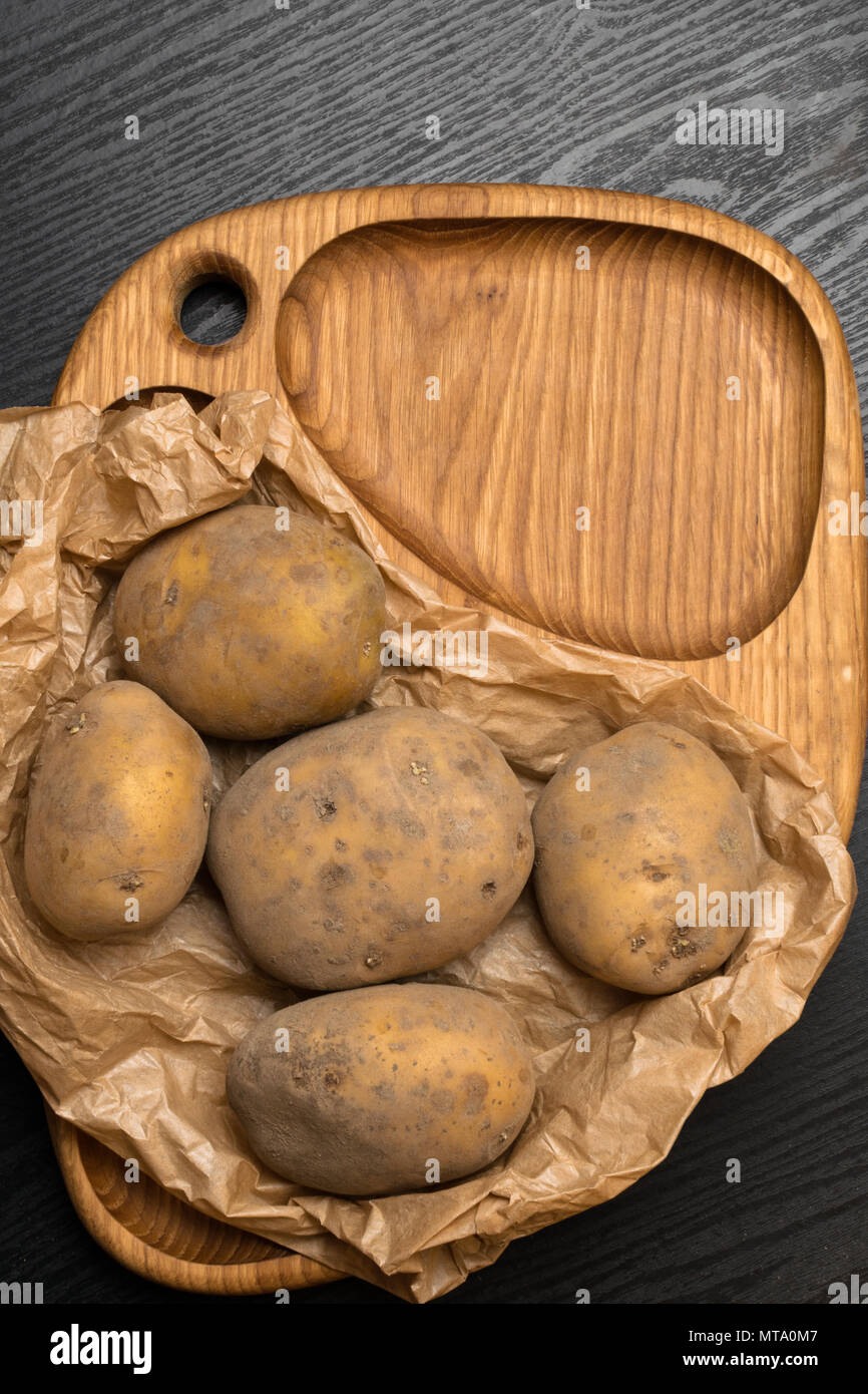 Pile of potatoes lying on wooden boards with a potato paper bag Stock ...