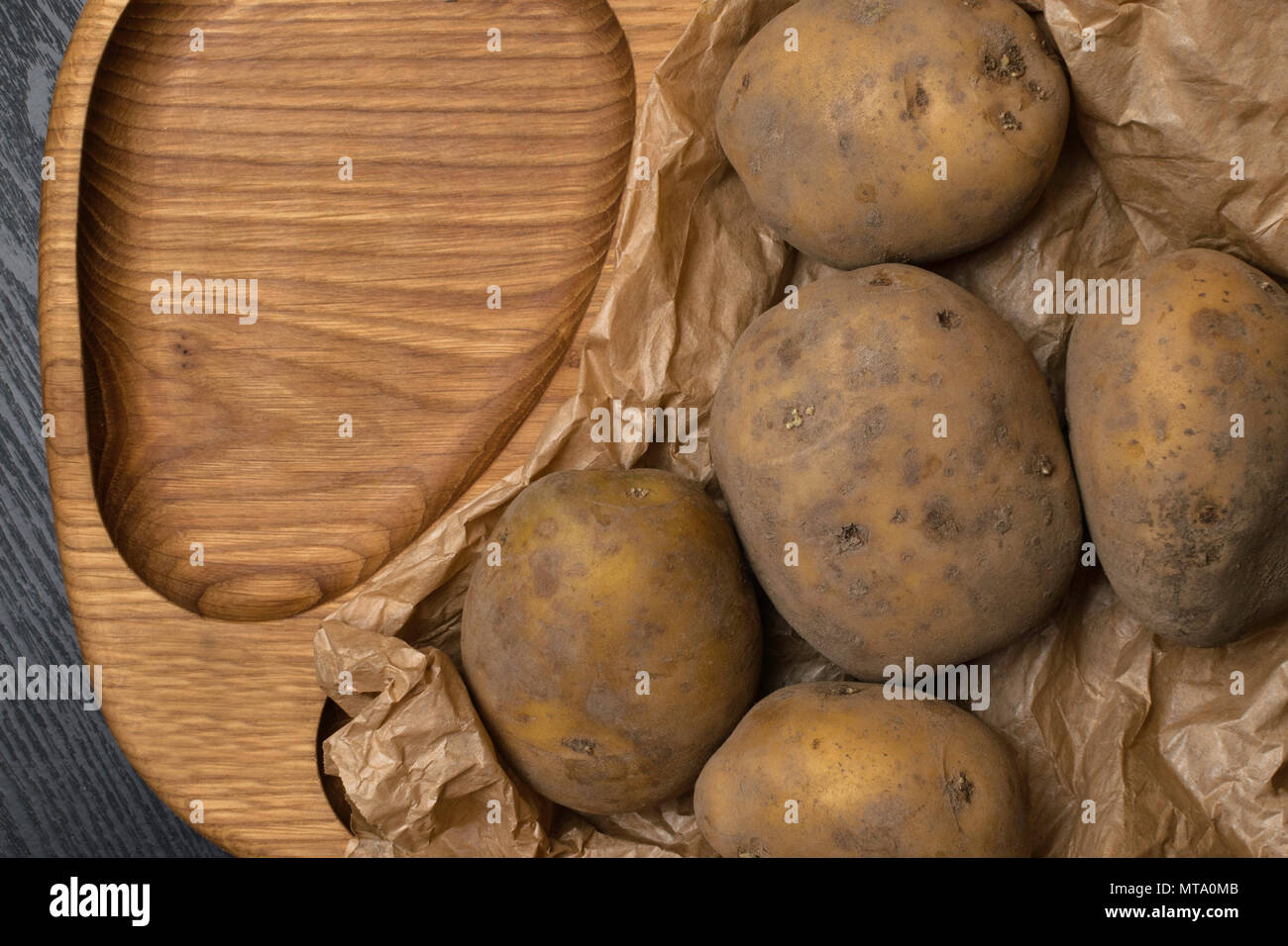 Pile of potatoes lying on wooden boards with a potato paper bag Stock ...