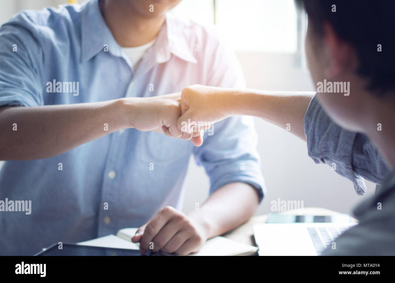 group of man punch in office, teamwork concept Stock Photo - Alamy