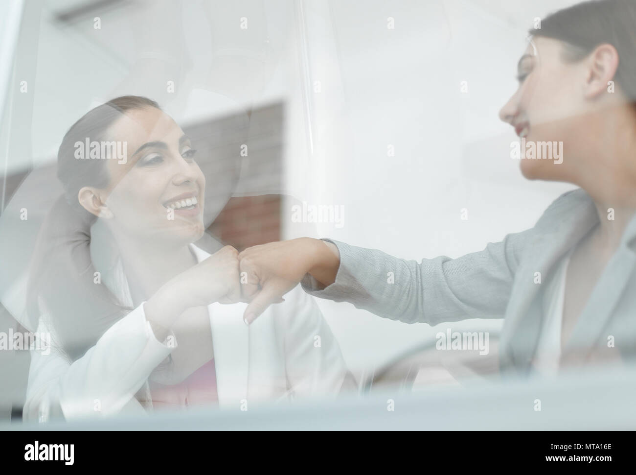 behind the glass.colleagues celebrate their success Stock Photo - Alamy