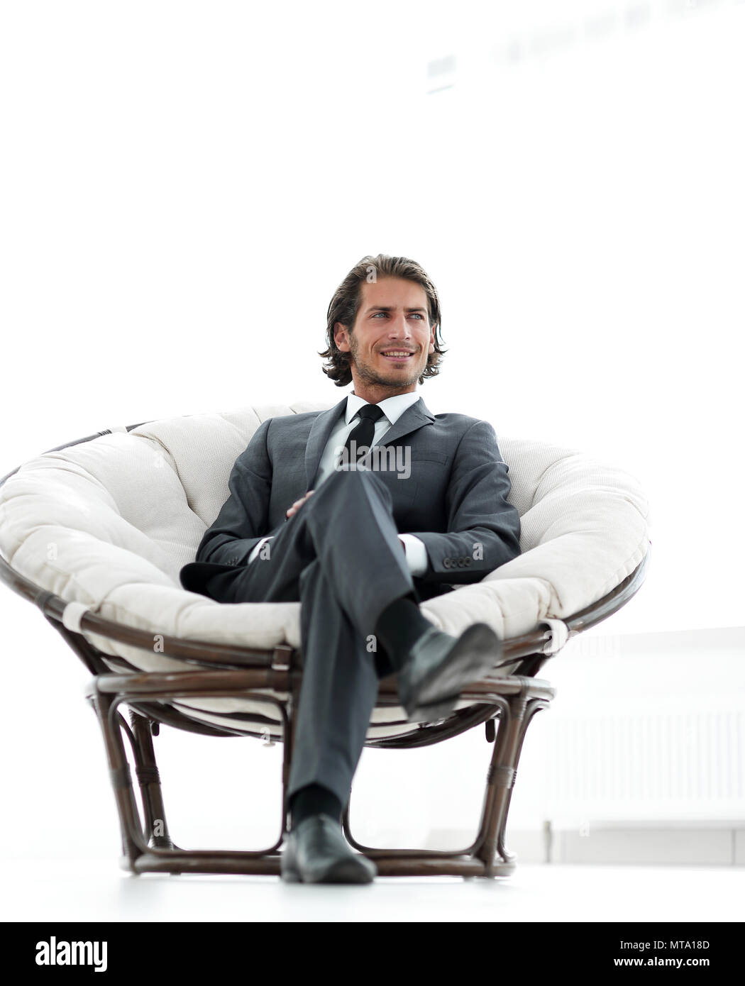 confident businessman sitting in a large comfortable chair Stock Photo ...